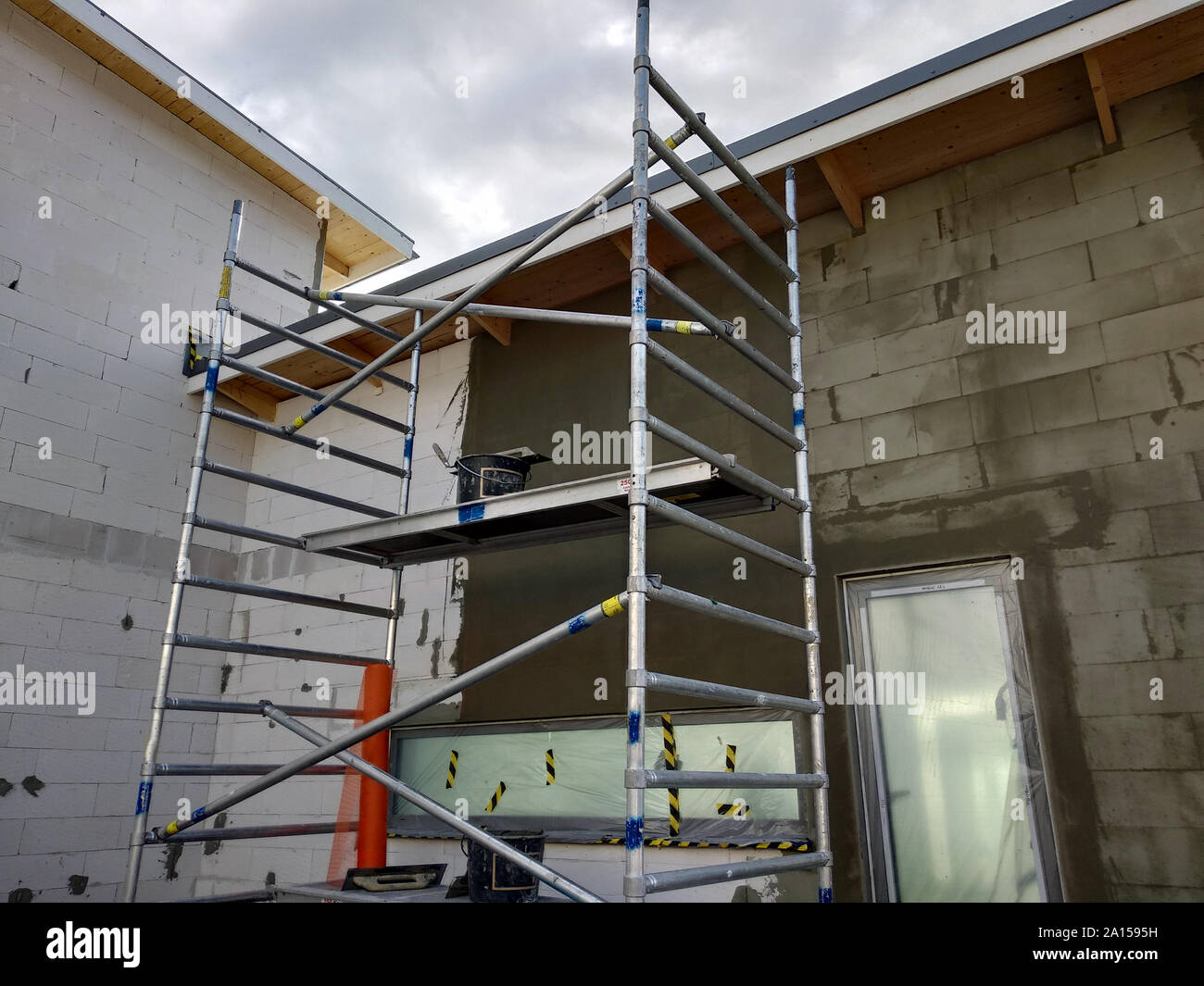 Facade of white block building under construction works Stock Photo - Alamy