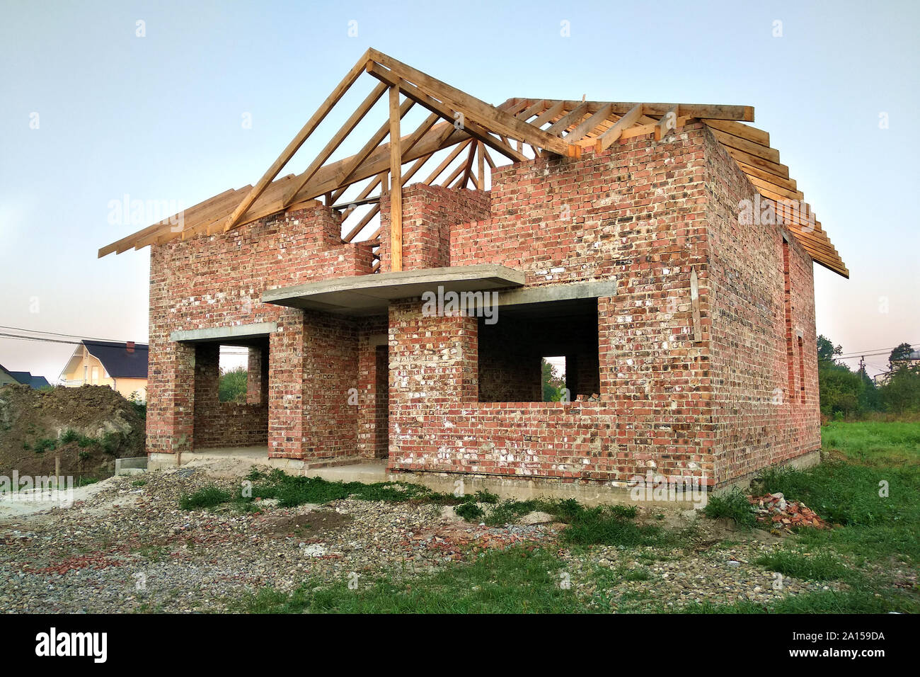 Brick residential house with wooden roof under construction Stock Photo ...