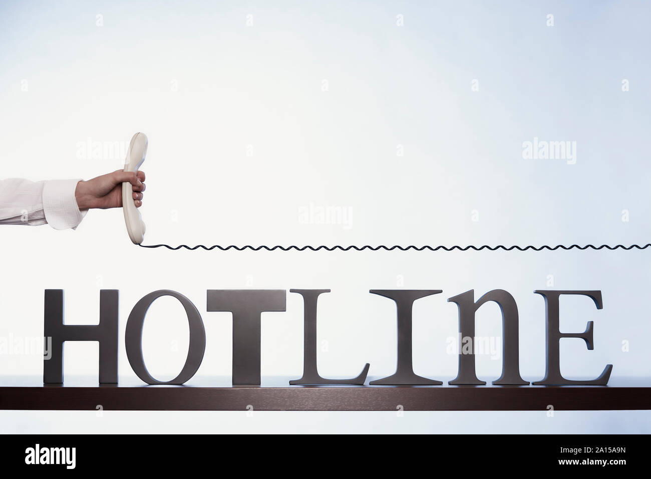 Hotline letters with phone receiver Stock Photo - Alamy