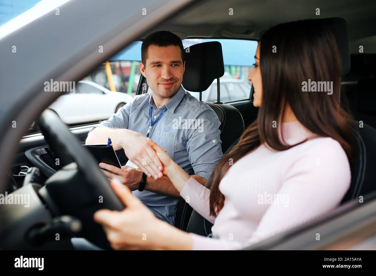 Learner driver instructor shaking hands car hi-res stock photography ...