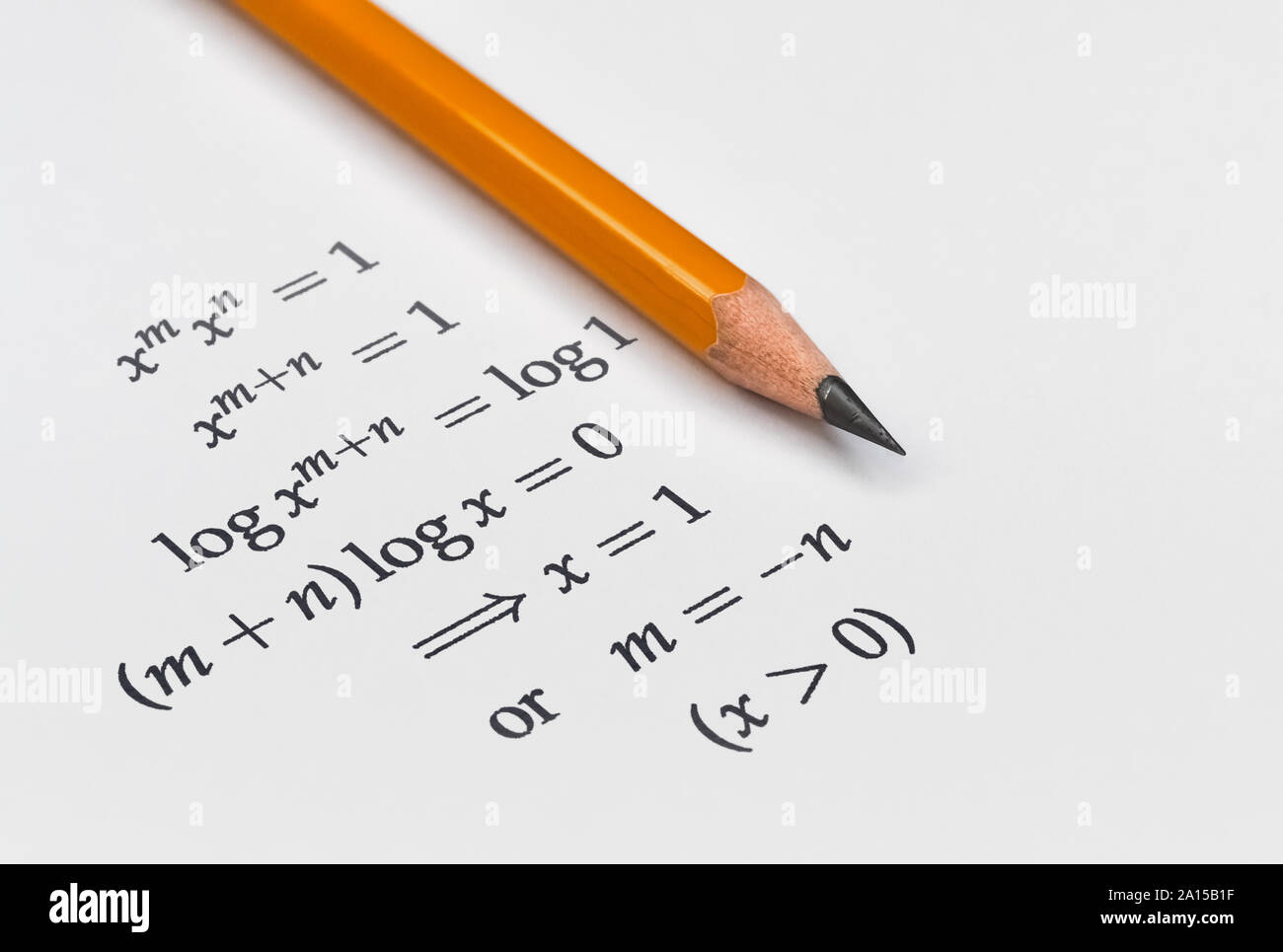 Math exercise and a yellow pencil on bright background Stock Photo - Alamy
