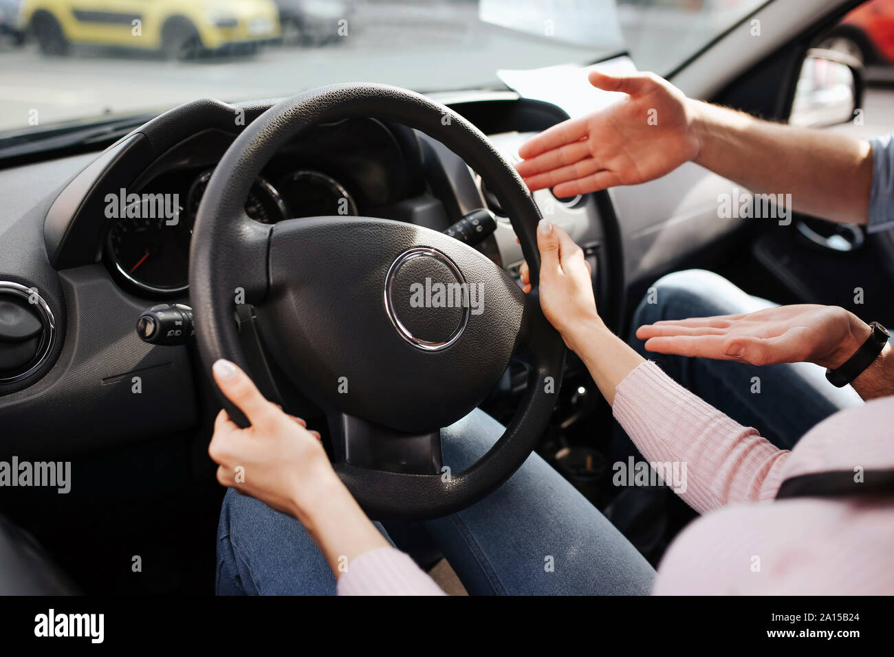 Male auto instructor takes exam in young woman. Cut view of woman's ...