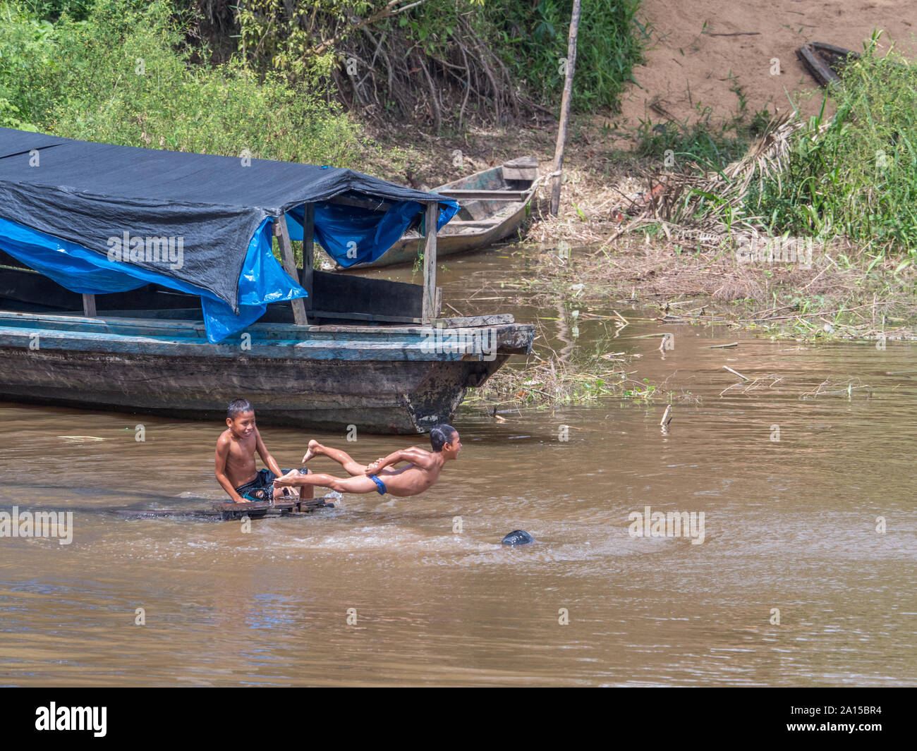 Amazon River, Peru- Dec 04, 2018: Children swimming and jumping in the ...