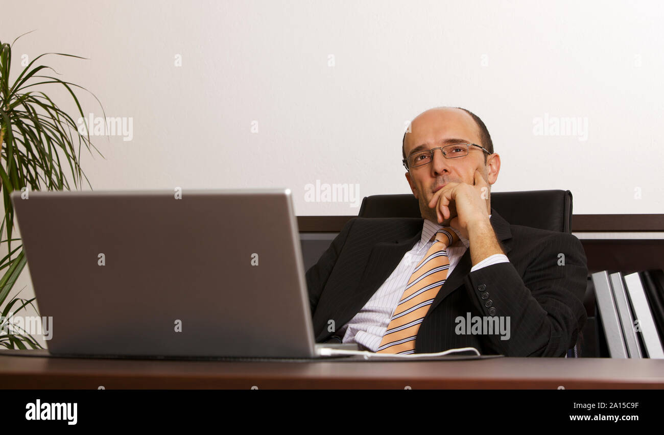 Confident businessman thinking Stock Photo - Alamy