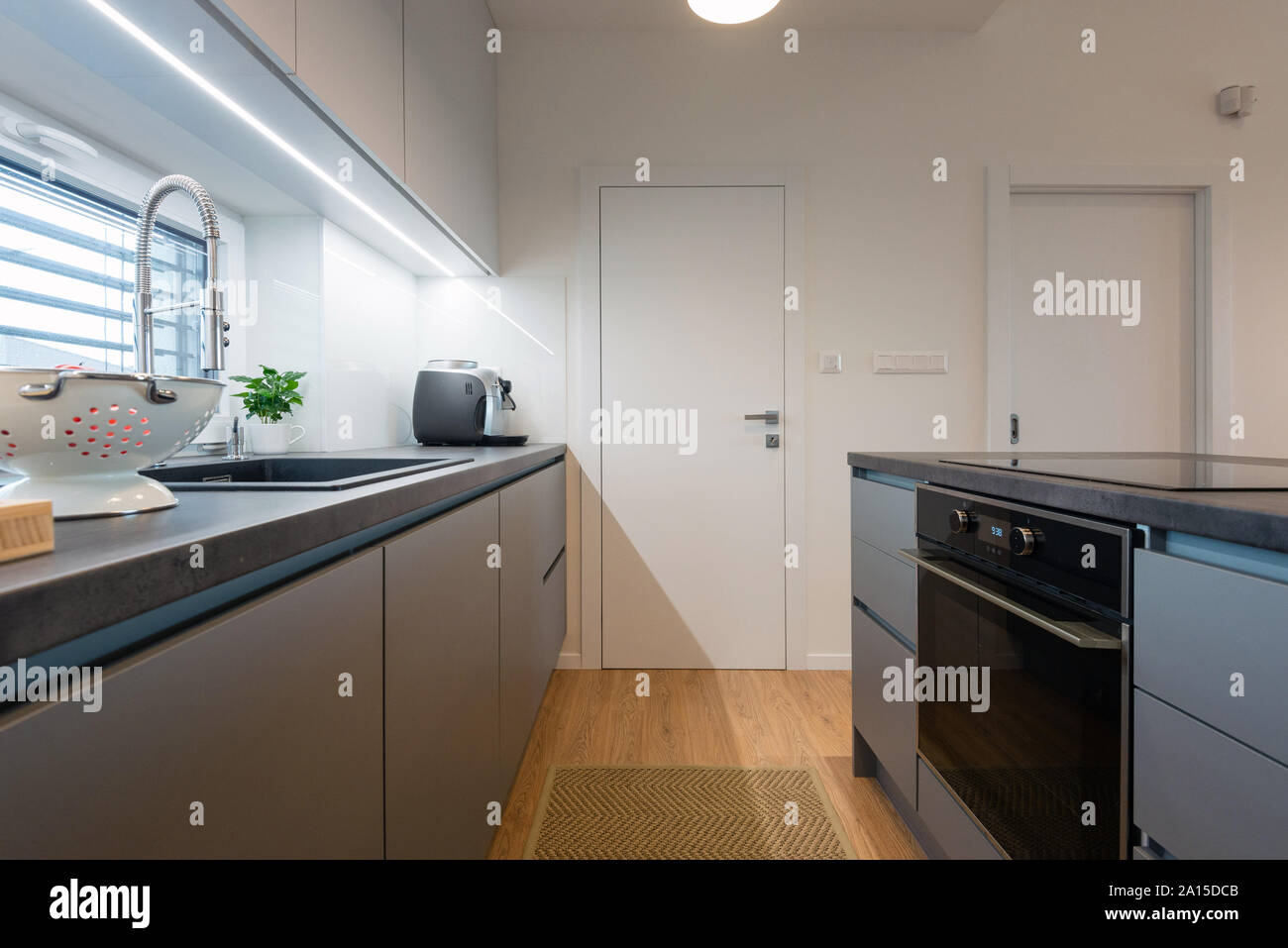 Interior of contemporary kitchen with built-in stove Stock Photo - Alamy