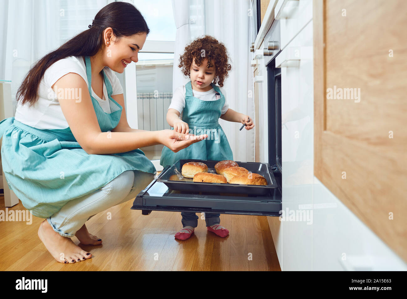 Mother playing teaches children to cook. Teaching parenting. Parenthood ...