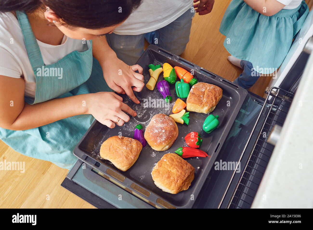 Mother playing teaches children to cook. Teaching parenting. Parenthood ...
