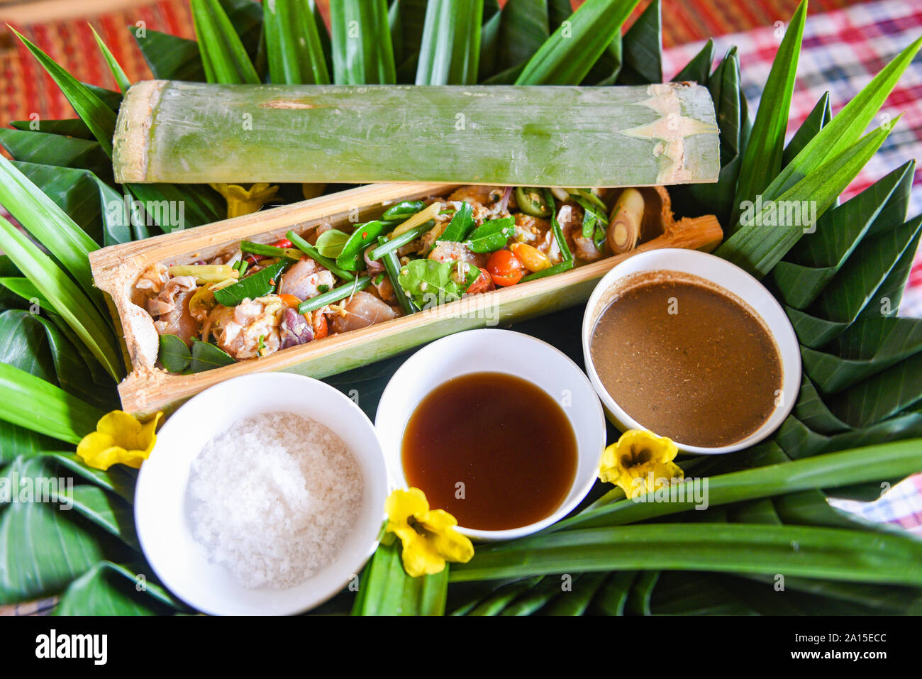 Chicken in bamboo for grilled on fire flame / Raw uncooked chicken meat ...