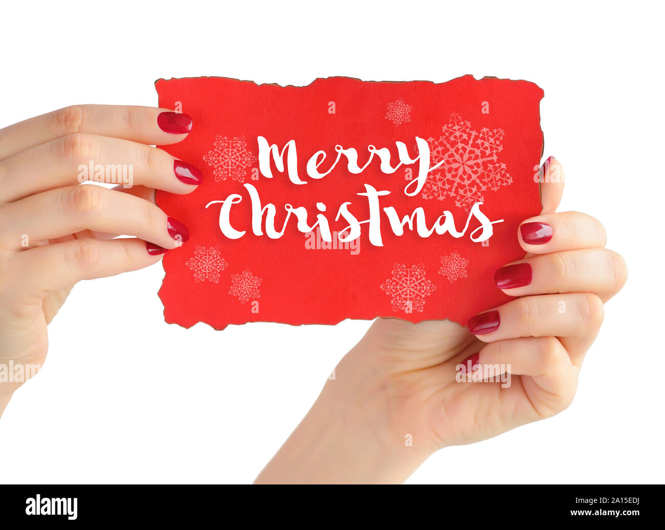 Greeting "Merry Christmas" on a red leaf in women's hands isolated on ...