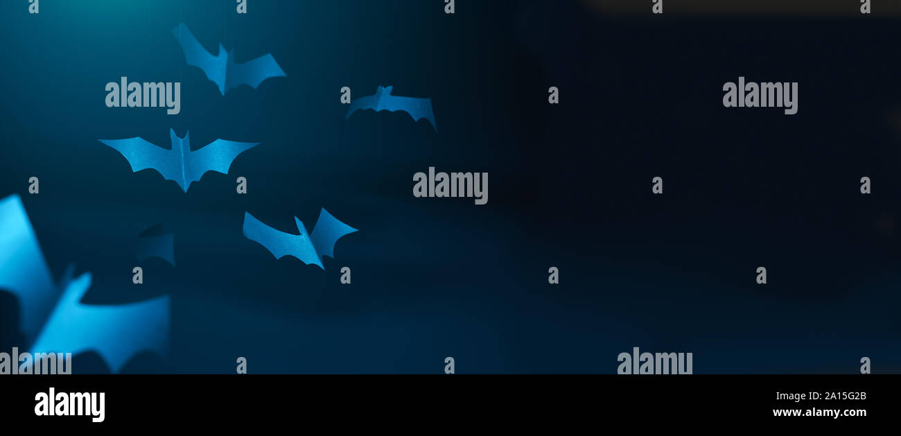 Halloween photo of blue paper bats on blank dark blue background. Space ...