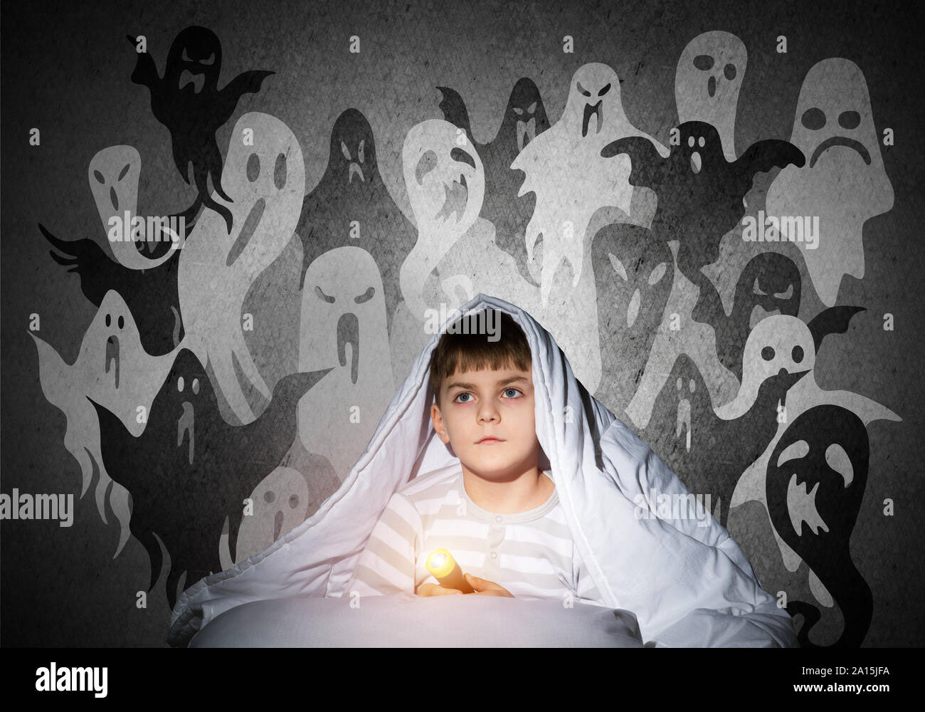 Little child with flashlight hiding under blanket. Halloween scary ...