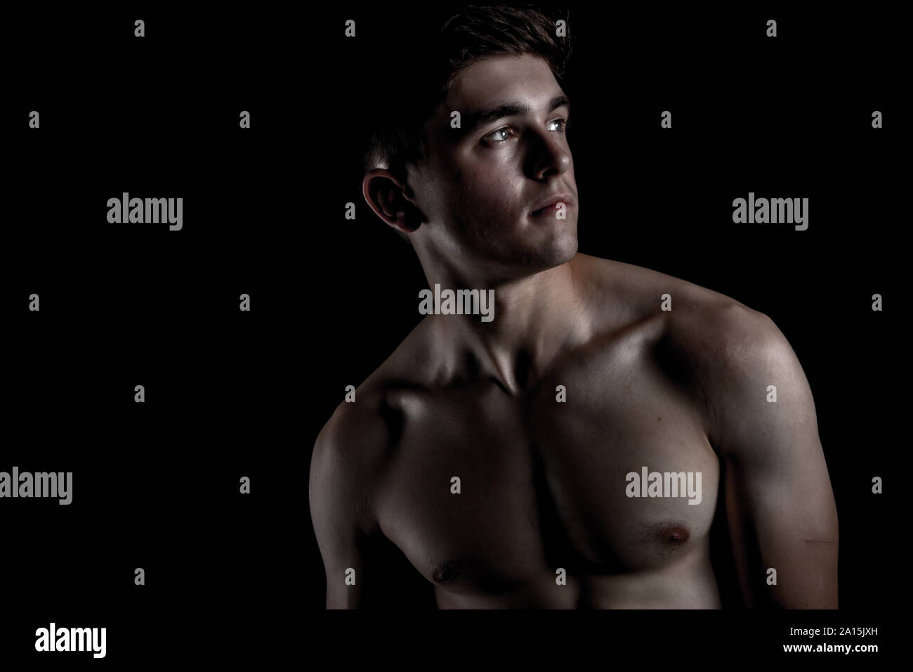 Low Key Studio Portrait Of A Shirtless Young Adult Caucasian Male ...