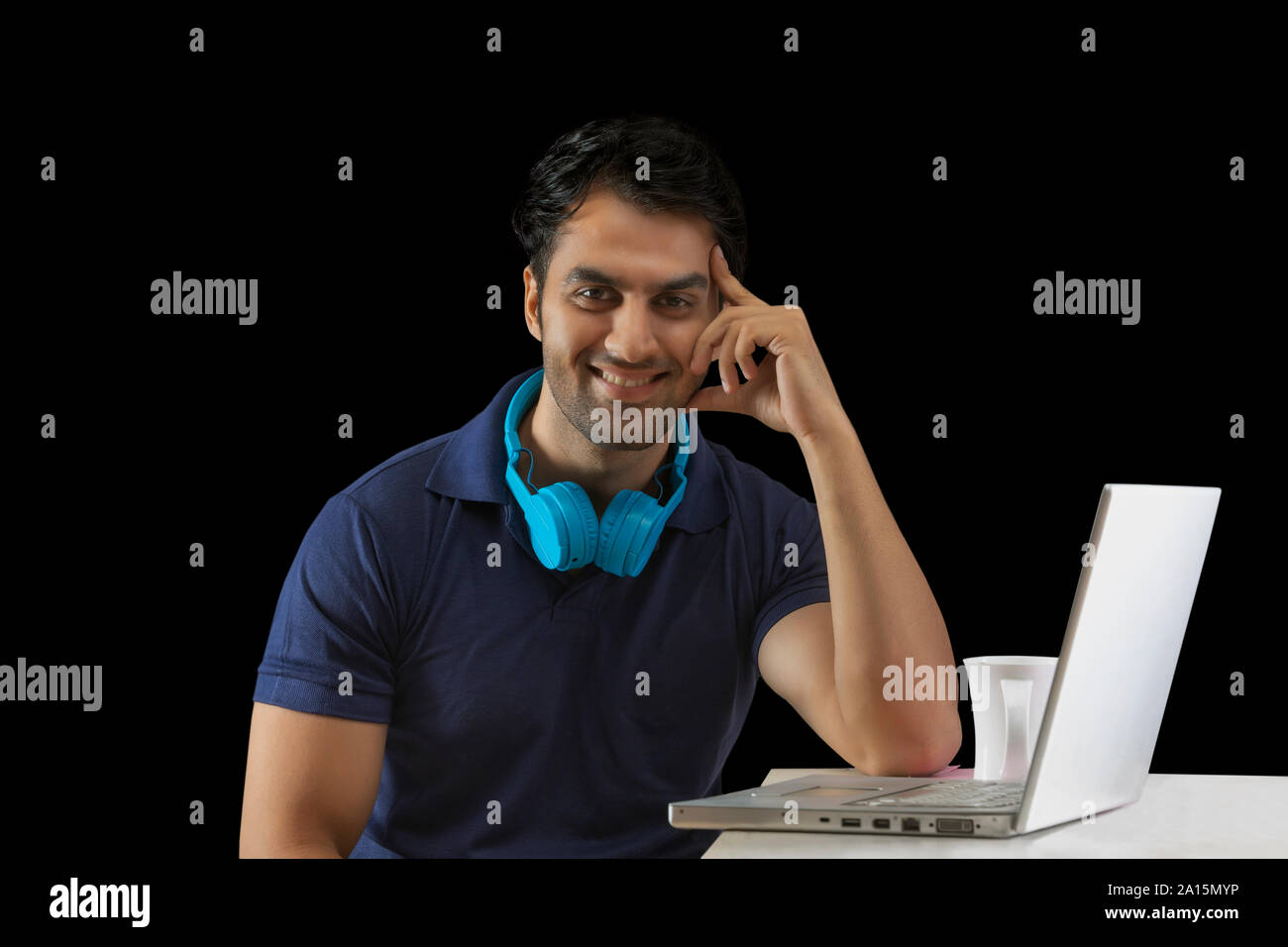 Young guy working using headset and laptop over black background hand ...
