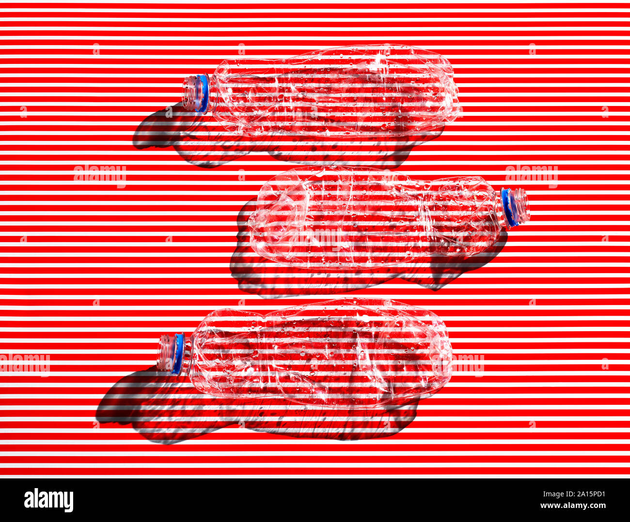Plastic bottles on red white striped background Stock Photo - Alamy