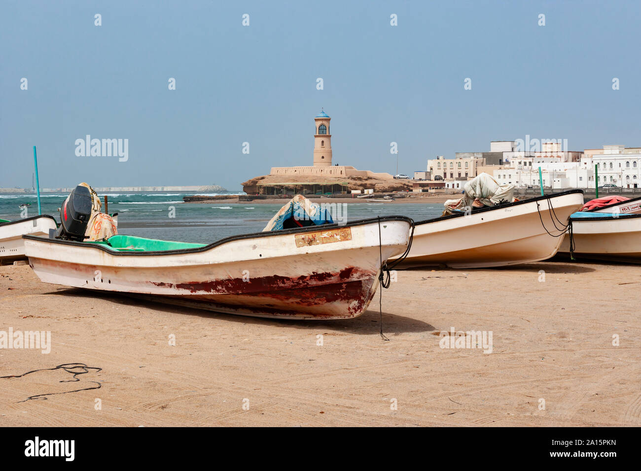 Fishing boats at the beach, Sur Lighthouse in the background, Sur, Oman ...