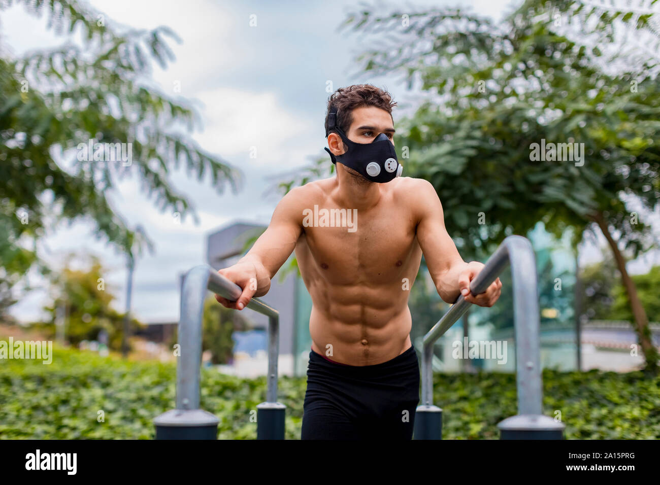Athlete training on bars in the city, wearing breathing mask Stock ...