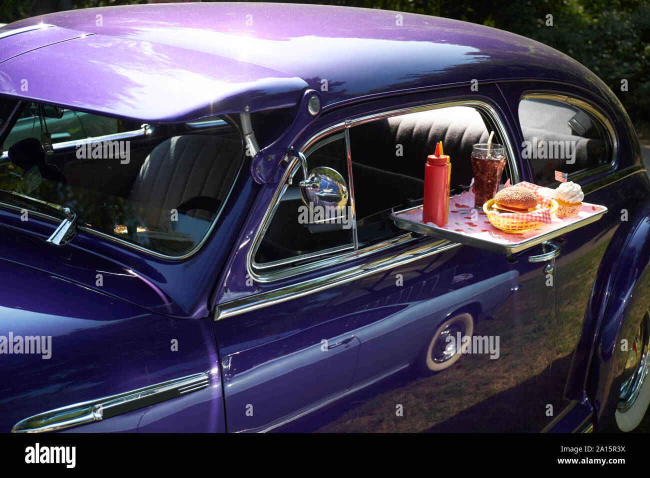 Typical American fast food on tray at vintage car, Chevrolet Fleetline ...