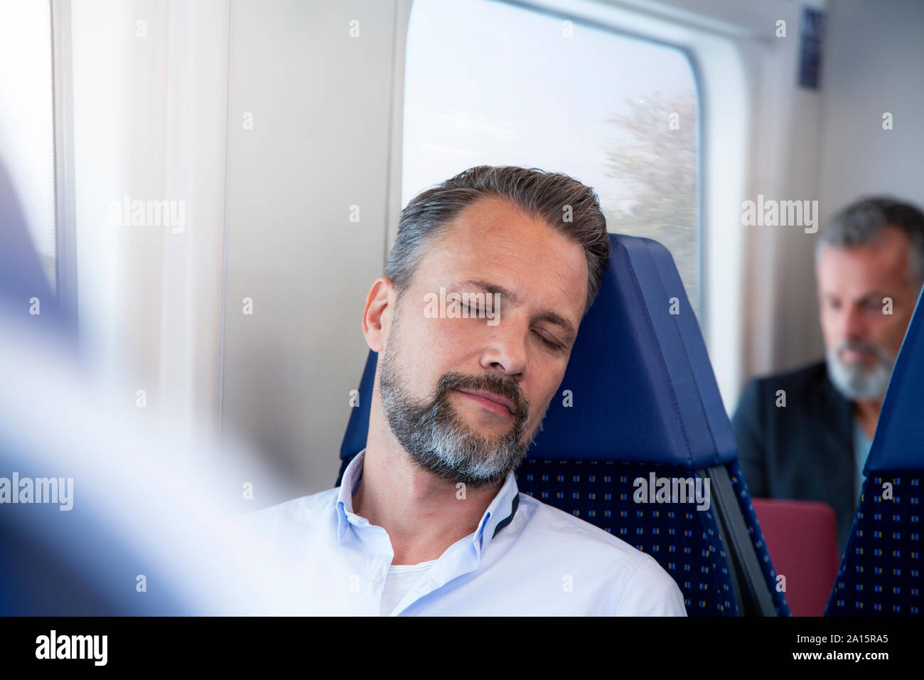 Two men sitting in train hi-res stock photography and images - Alamy