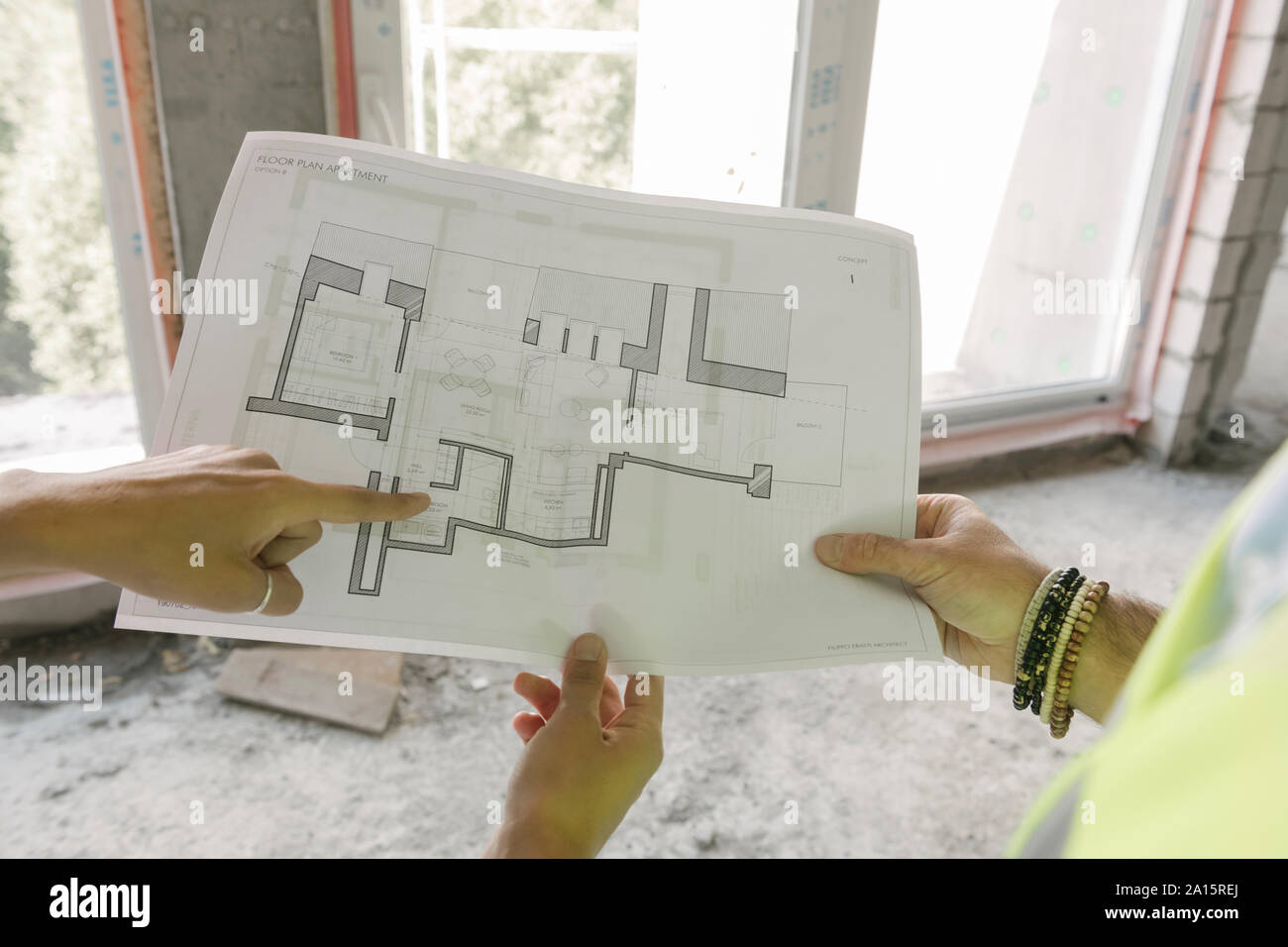 Two architects pointing a architectural plan at construction site Stock ...