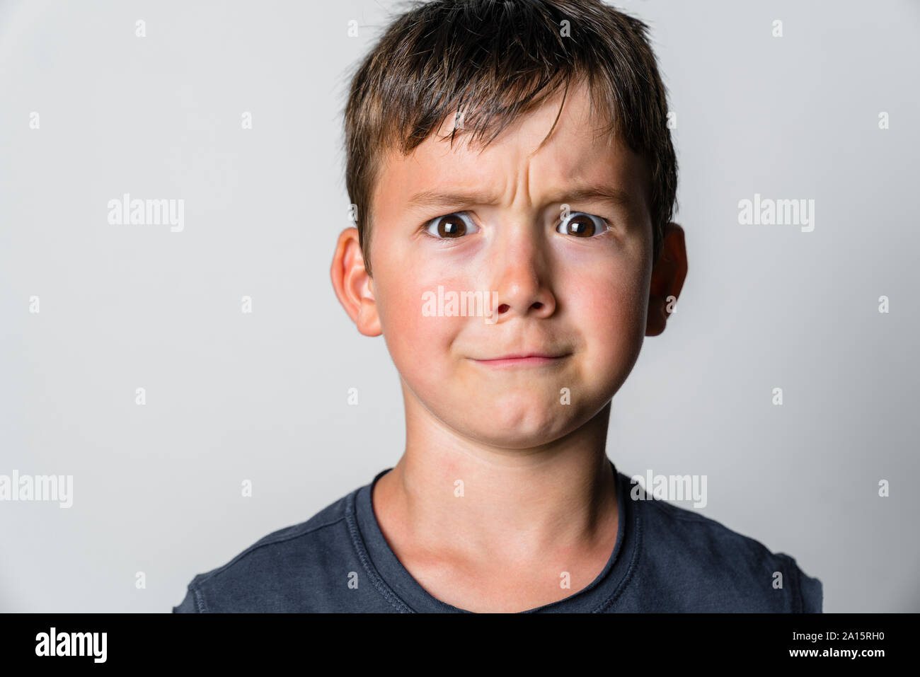 Portrait of boy, doubting, white background Stock Photo - Alamy