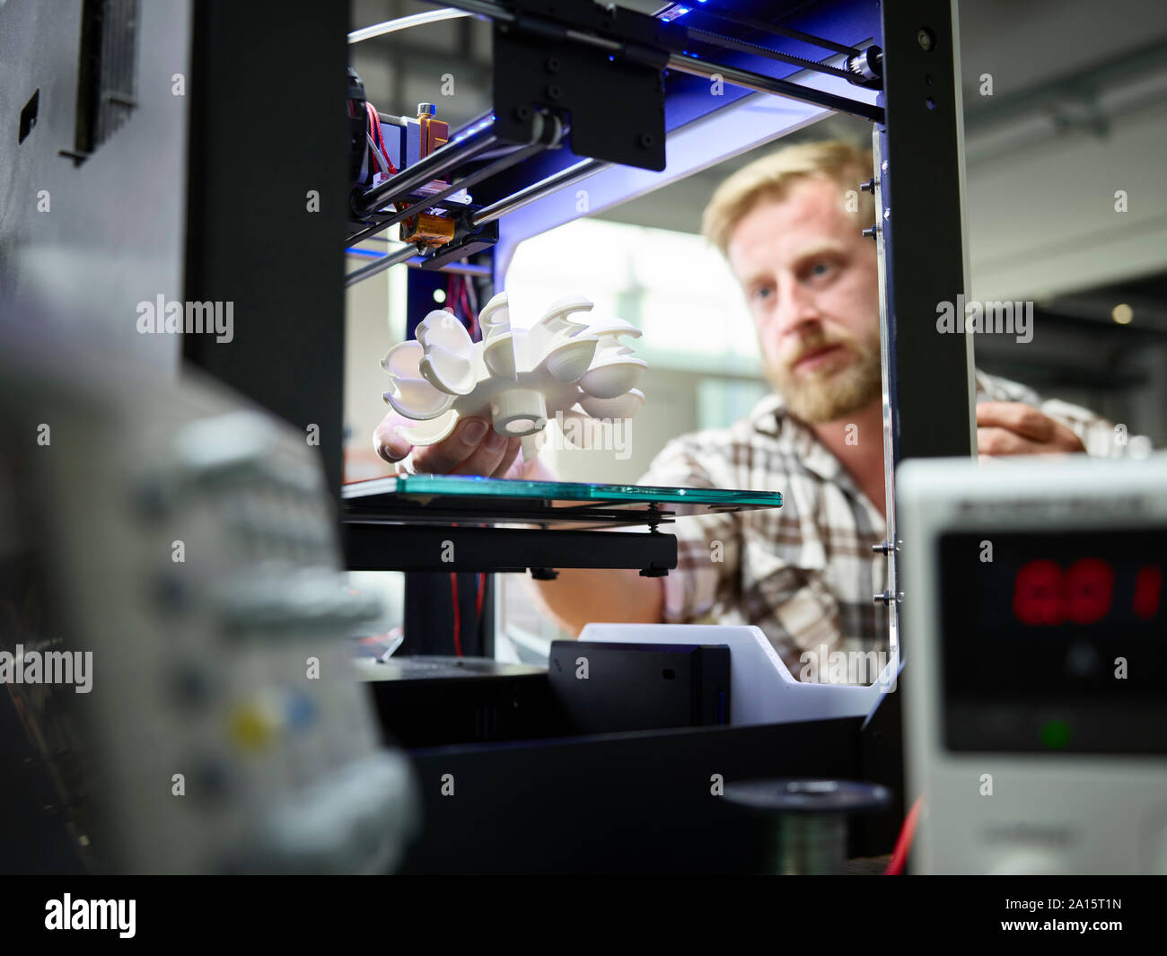 Technician with turbine wheel being printed in 3d printer Stock Photo ...