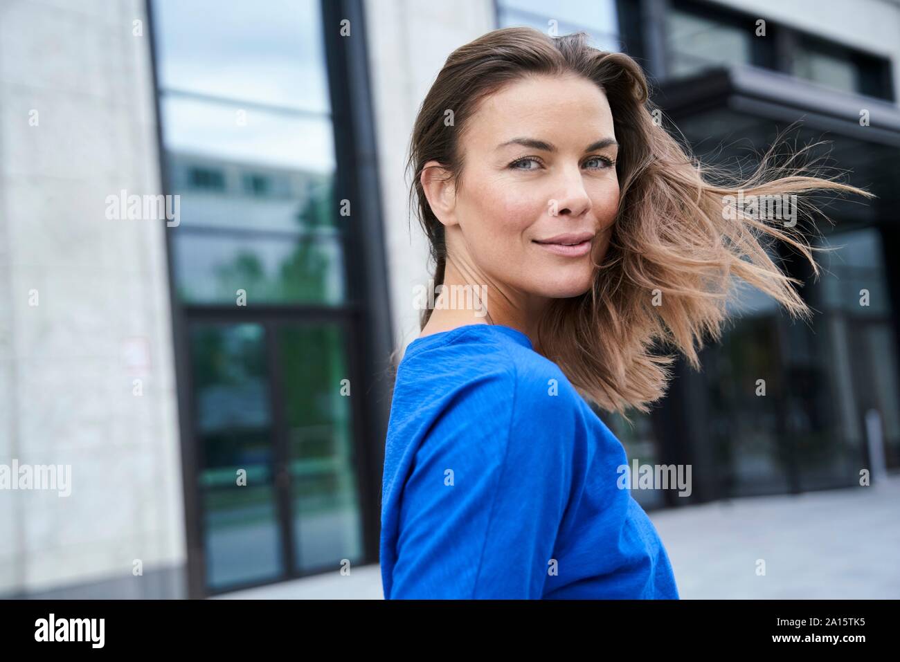 Portrait of attractive brunette woman in the city turning round Stock ...