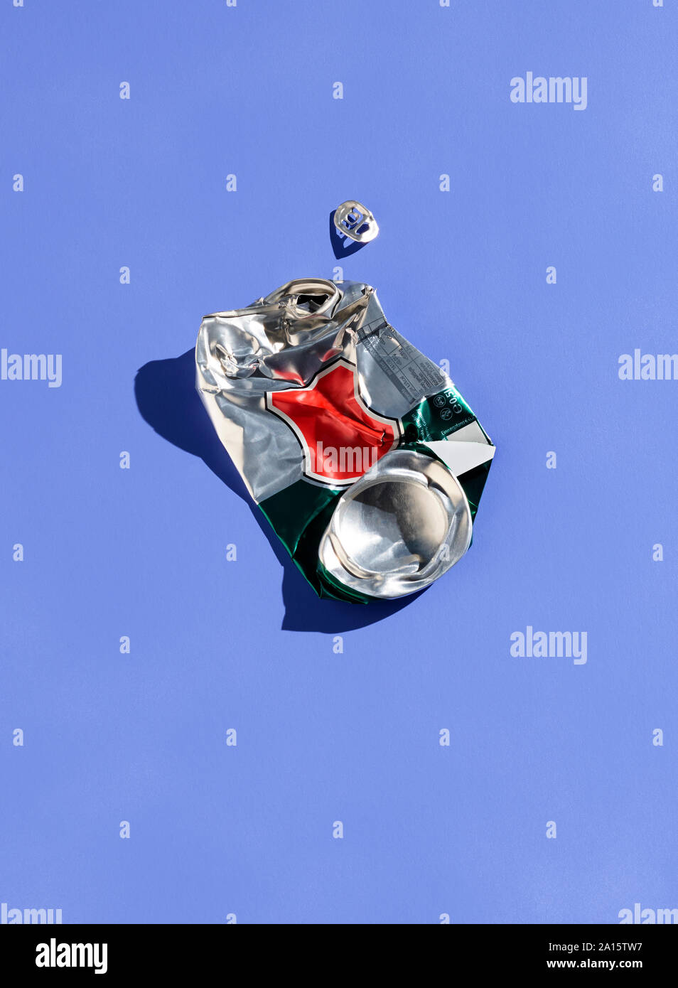 Crushed tin can on purple background Stock Photo - Alamy