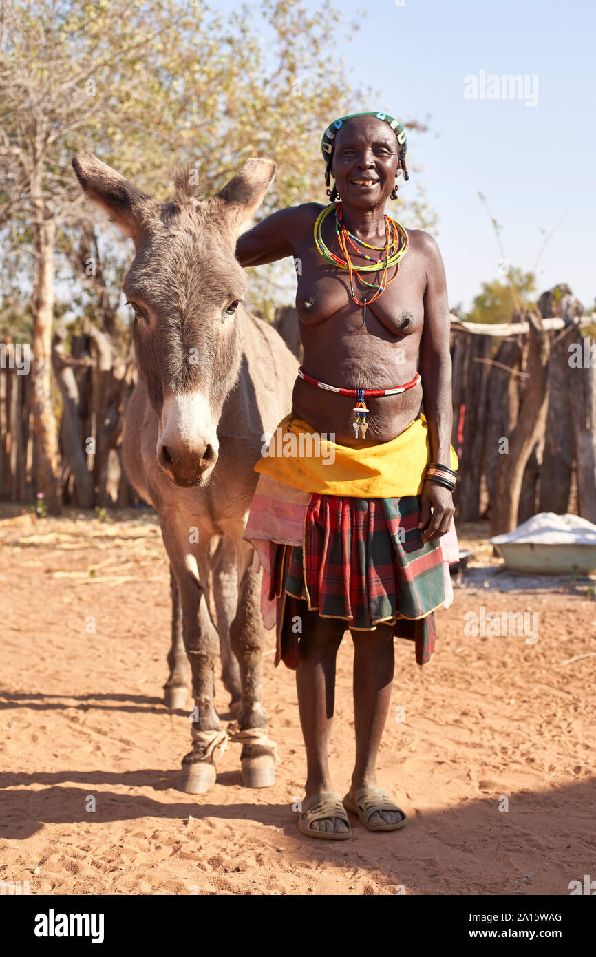 Traditional Mudimba tribe woman and her donkey, Canhimei, Angola Stock ...
