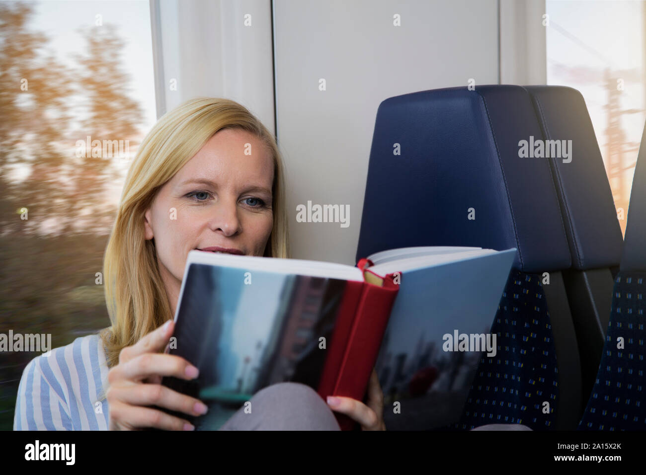 Woman reading on train window hi-res stock photography and images - Alamy