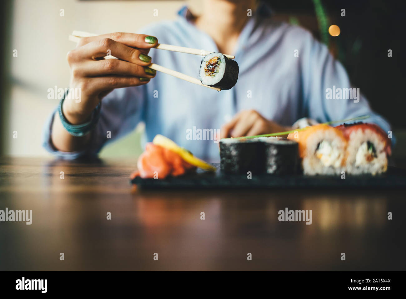 Woman eating sushi hi-res stock photography and images - Alamy