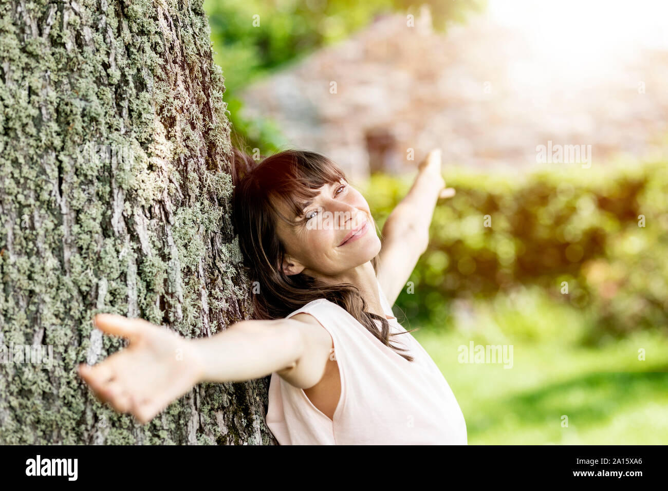 Person leaning against a tree hi-res stock photography and images - Alamy