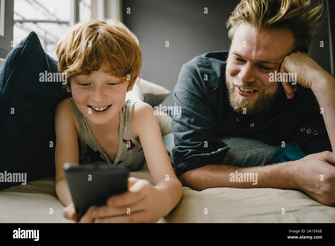 Father son looking phone hi-res stock photography and images - Alamy