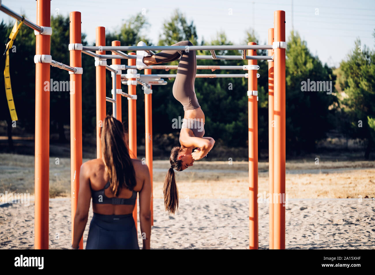 Two young women doing workout on calisthenics bars Stock Photo - Alamy
