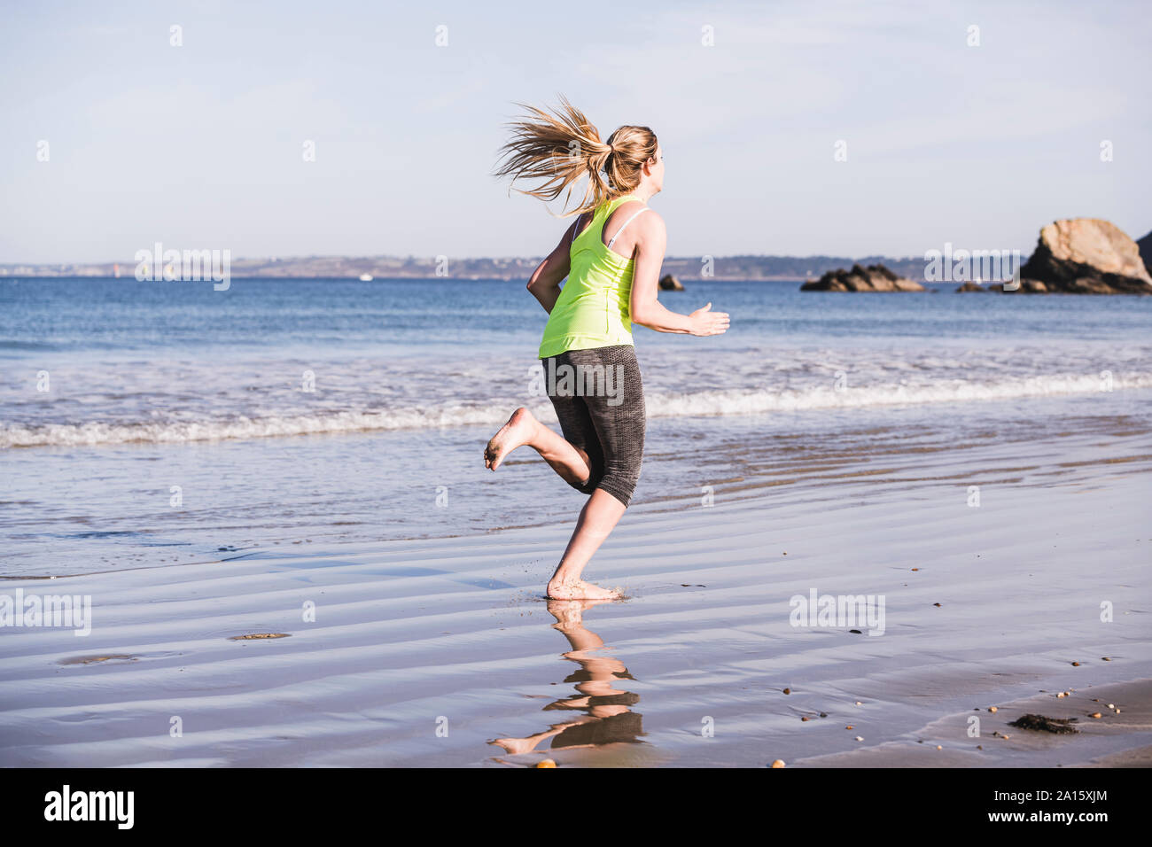 Female jogger at the beach Stock Photo - Alamy