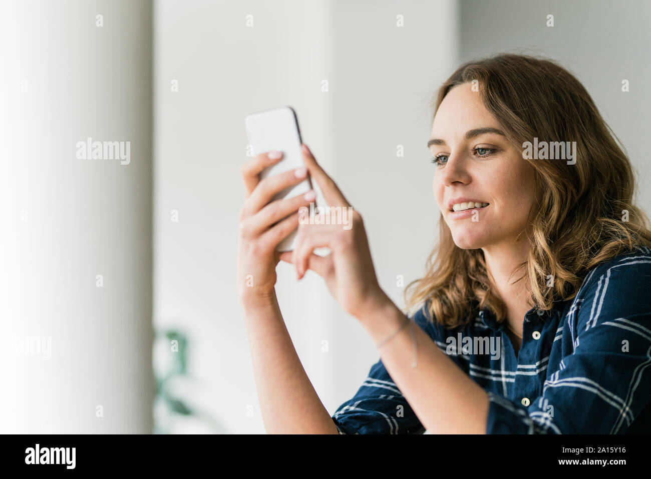 Business woman smiling using smartphone hi-res stock photography and ...