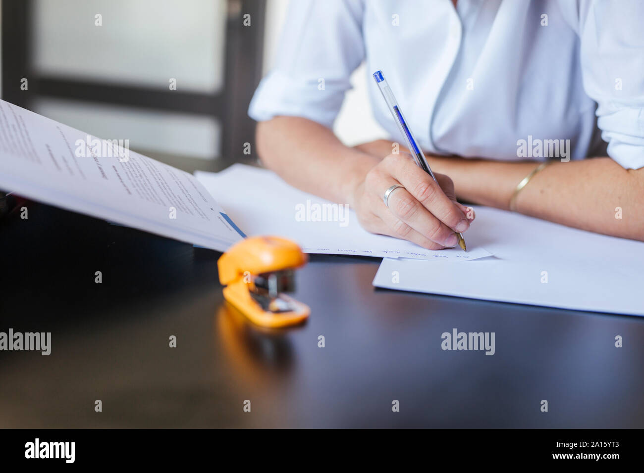 Close-up of female student learning at desk at home taking notes Stock ...