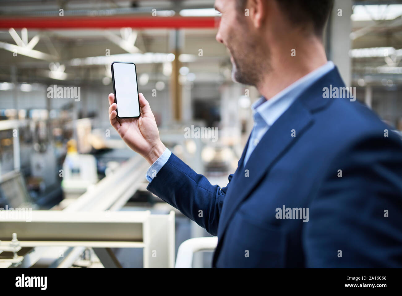 Hand holding smartphone factory workshop hi-res stock photography and ...