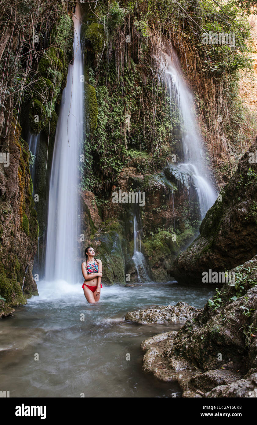 Young woman posing at a waterfall Stock Photo - Alamy