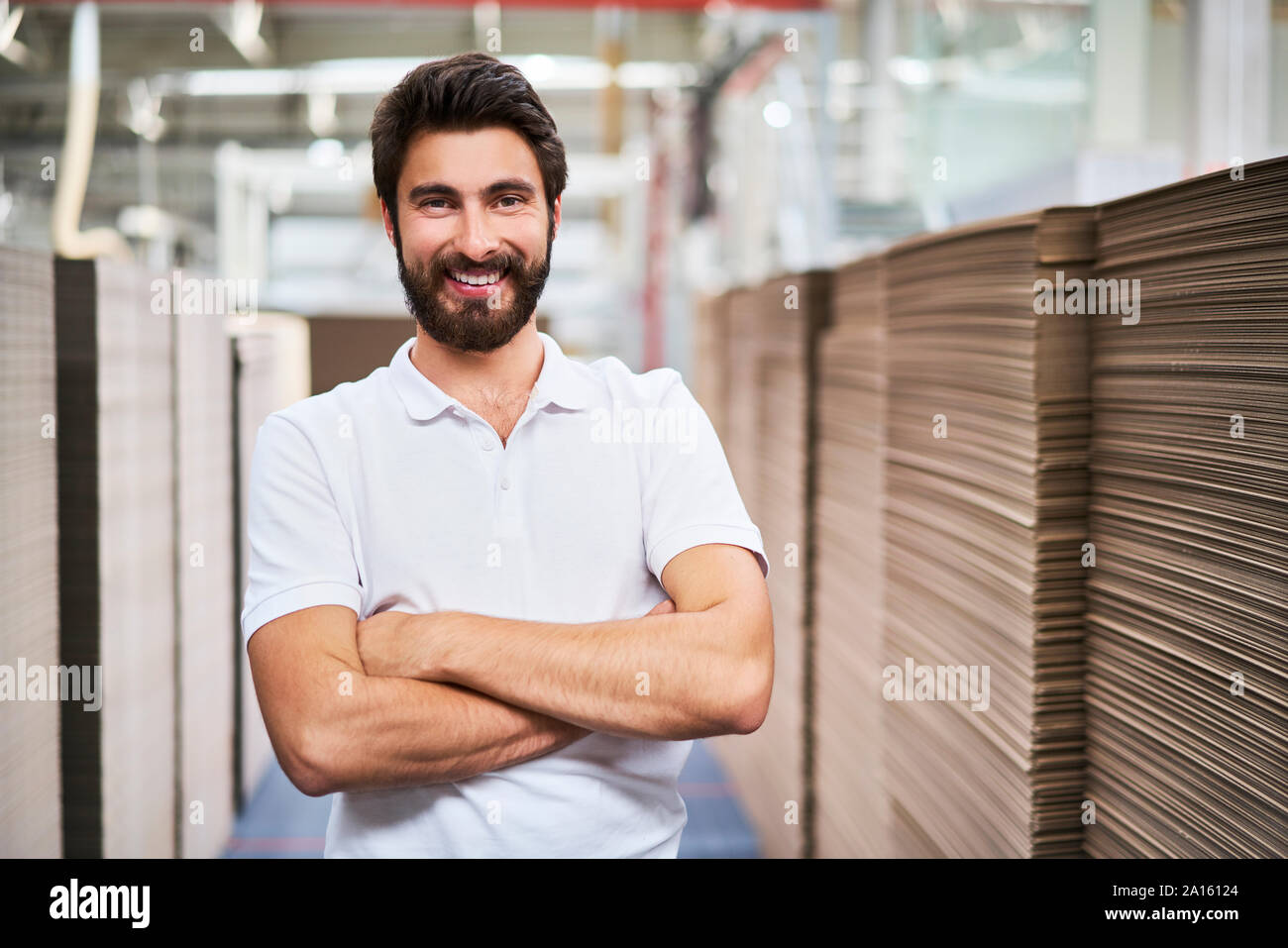 Portrait of smiling man in factory hall Stock Photo - Alamy