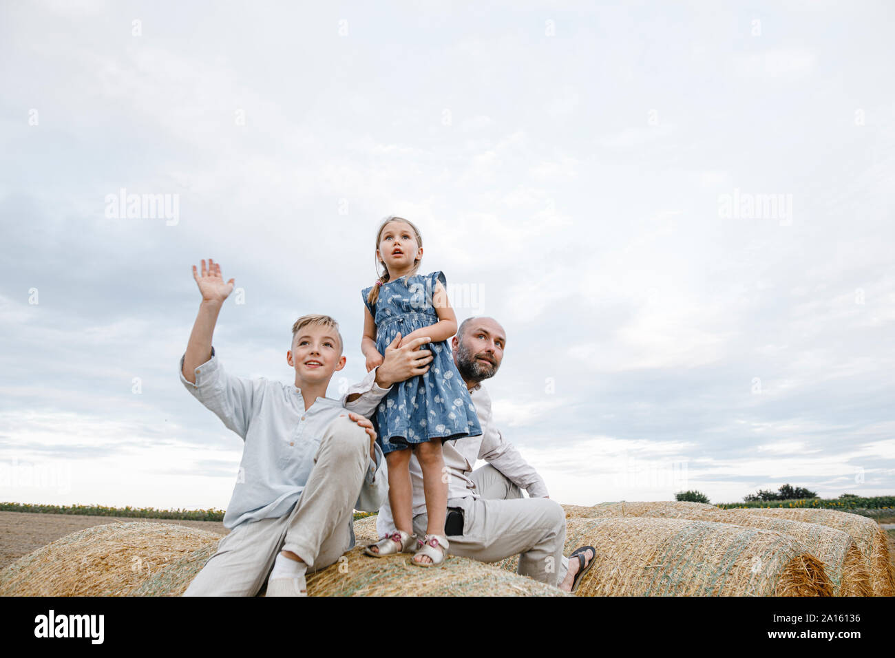 Boy sitting on hay bale hi-res stock photography and images - Alamy