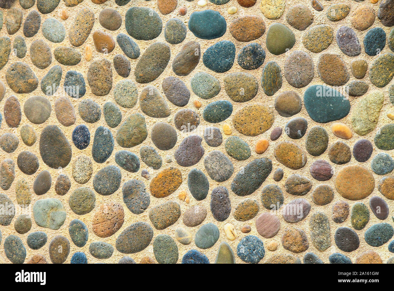 Wall of multicolored pebbles, decorative material, industrial and ...