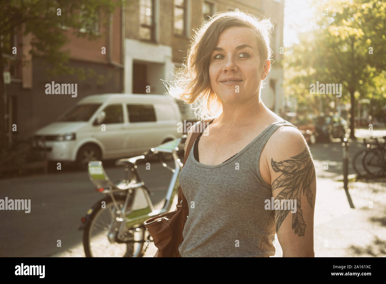 Tattooed woman on the street in the city Stock Photo - Alamy
