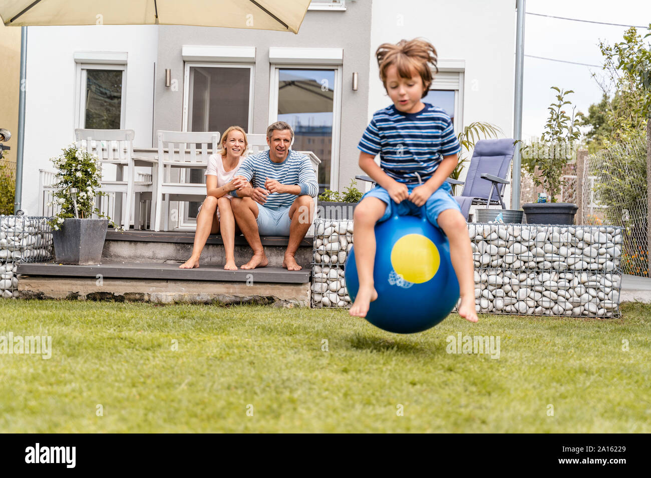 Boy bouncing ball hi-res stock photography and images - Alamy