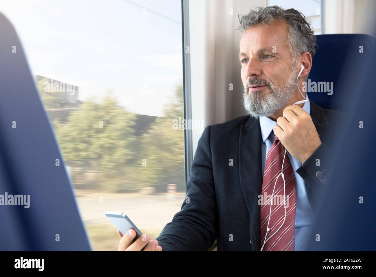 Person with smartphone and train hi-res stock photography and images ...