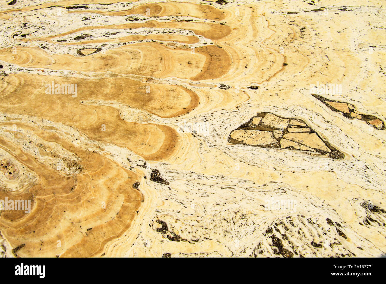 Unusual pattern on the smooth surface of the yellow old stone, stone ...