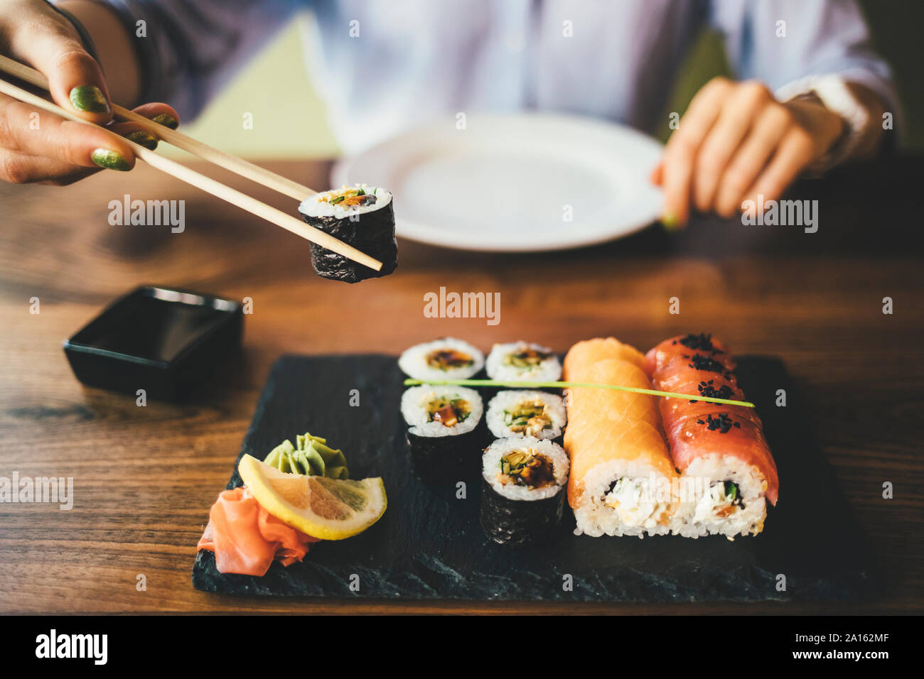 Woman eating sushi hi-res stock photography and images - Alamy