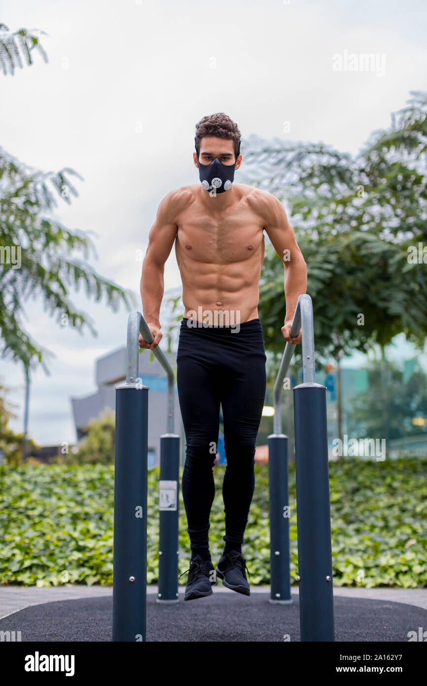 Athlete training on bars in the city, wearing breathing mask Stock ...