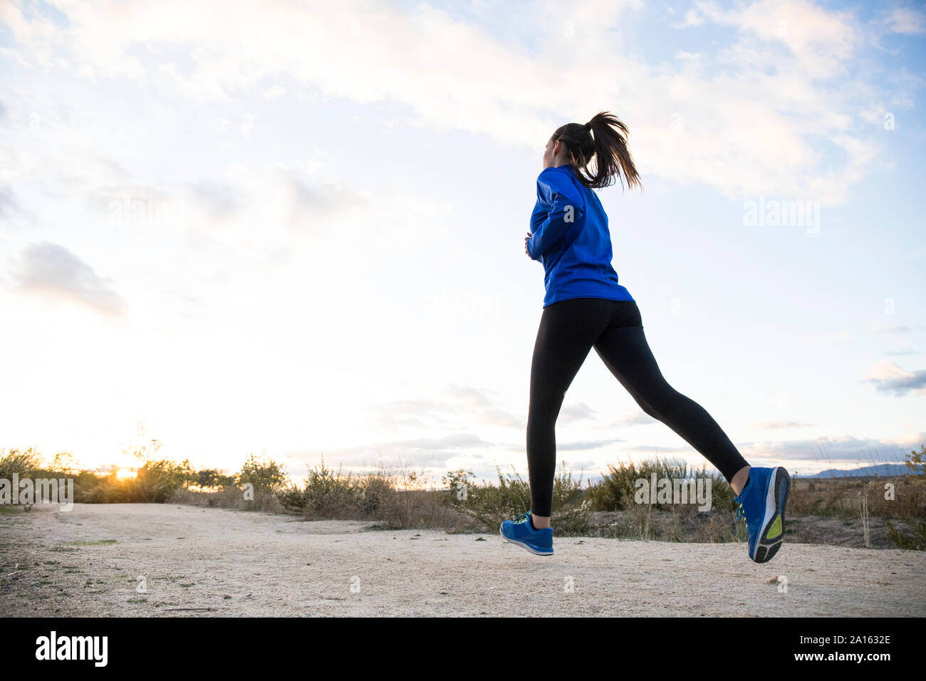 Woman running on countryside road hi-res stock photography and images ...