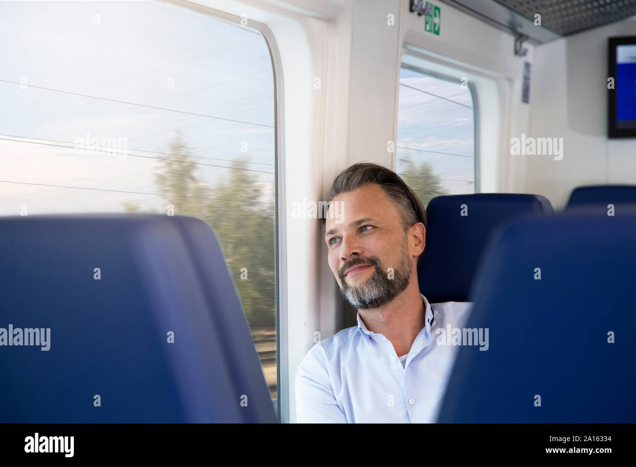 Man looking out train window hi-res stock photography and images - Alamy