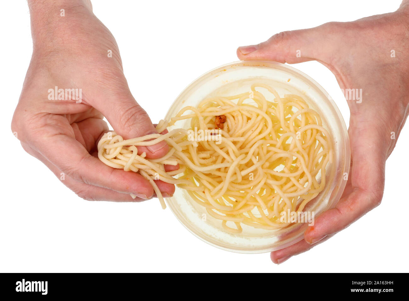 Old poor man eat with hands long boiled spaghetti pasta from plastic ...